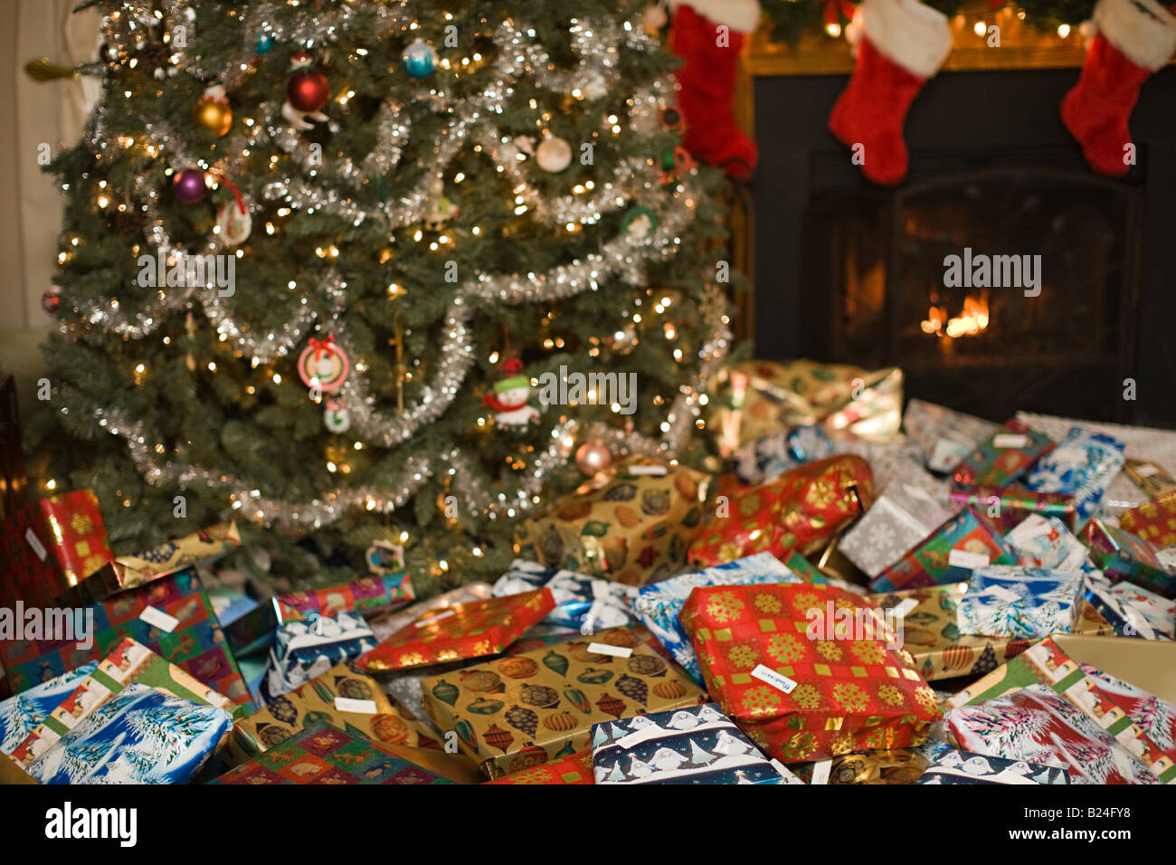 Christmas gifts by tree Stock Photo - Alamy