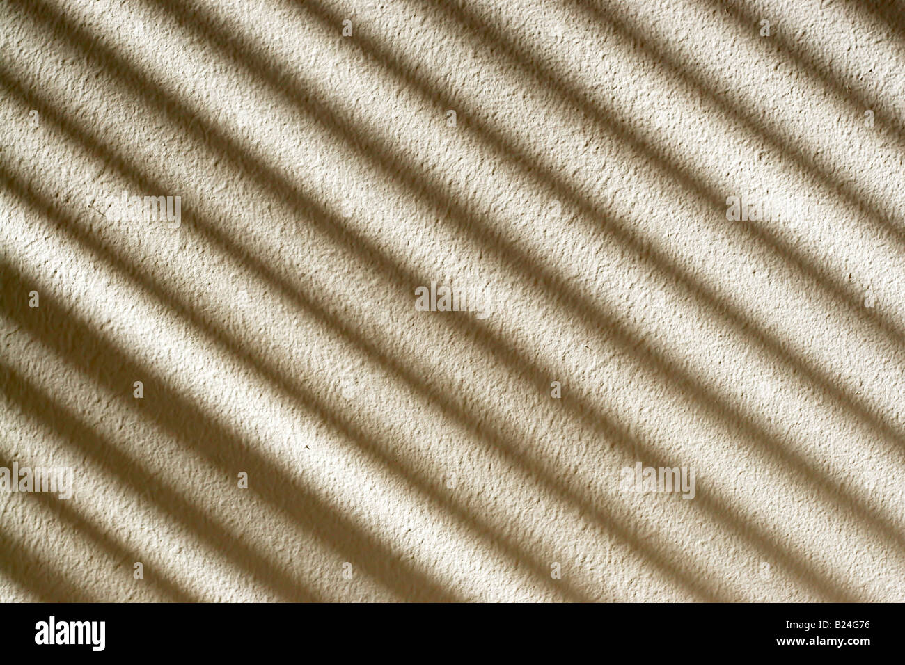 The light shining in through the blinds creating an interesting pattern ...