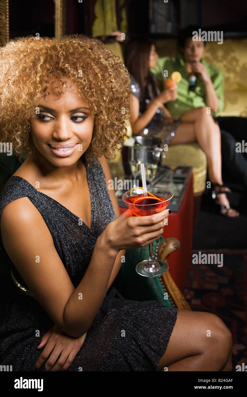 Portrait of a woman holding a cocktail Stock Photo - Alamy