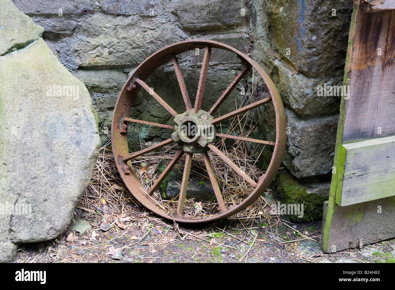 Old carriage wheel outside blacksmiths forge Stock Photo - Alamy