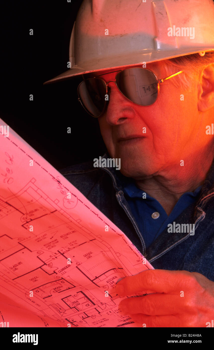 Male architect reading plans Stock Photo - Alamy