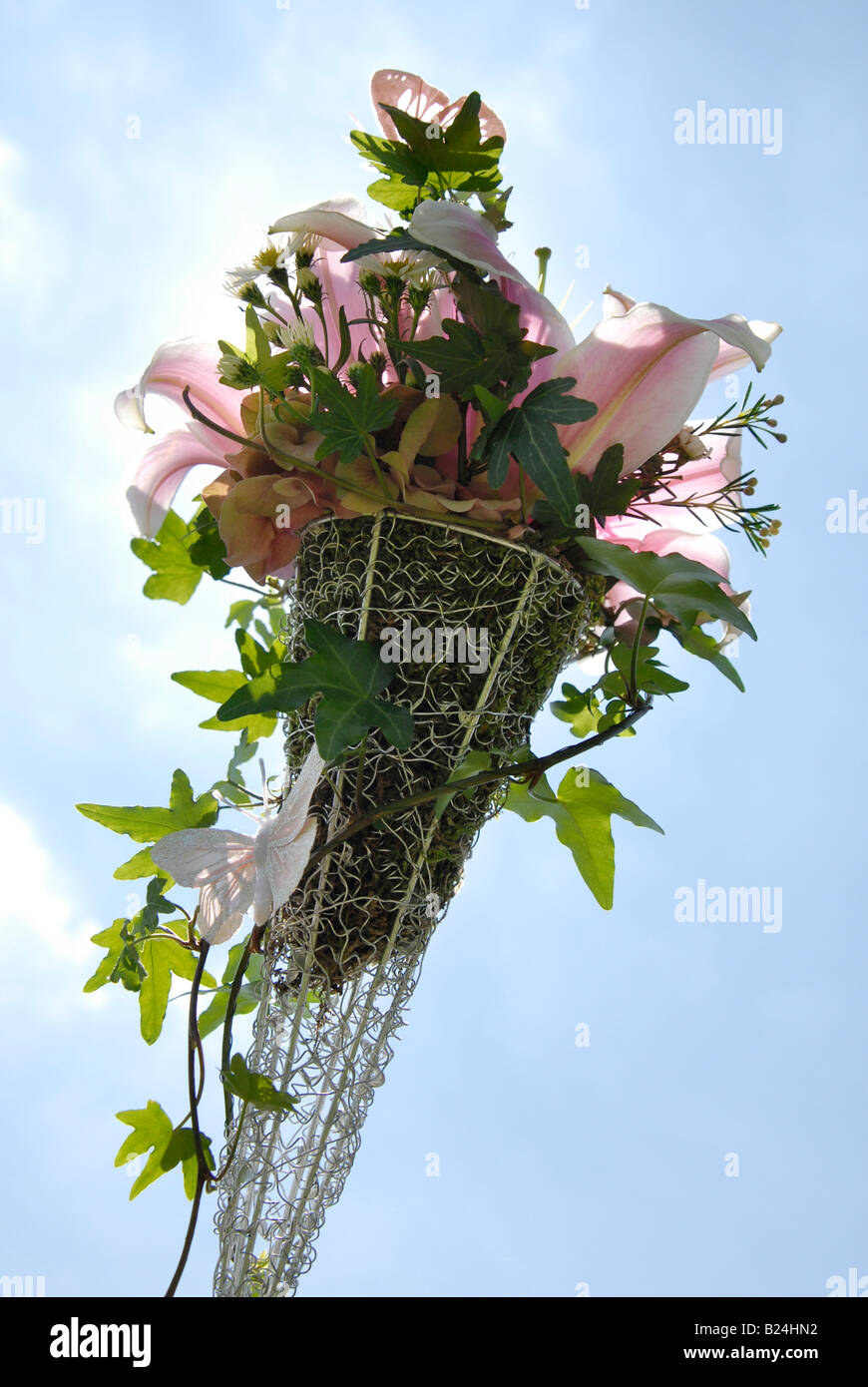 A cornucopia of flowers, a bride's bouquet, against a blue English ...
