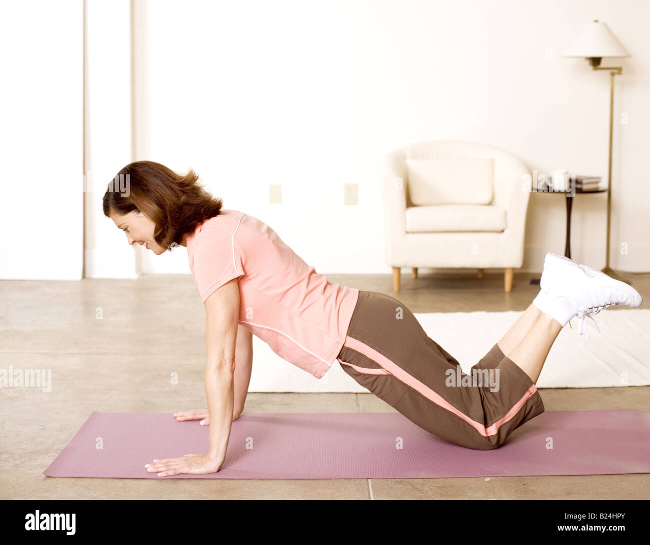 A female model demonstrating an exercise movement Stock Photo - Alamy