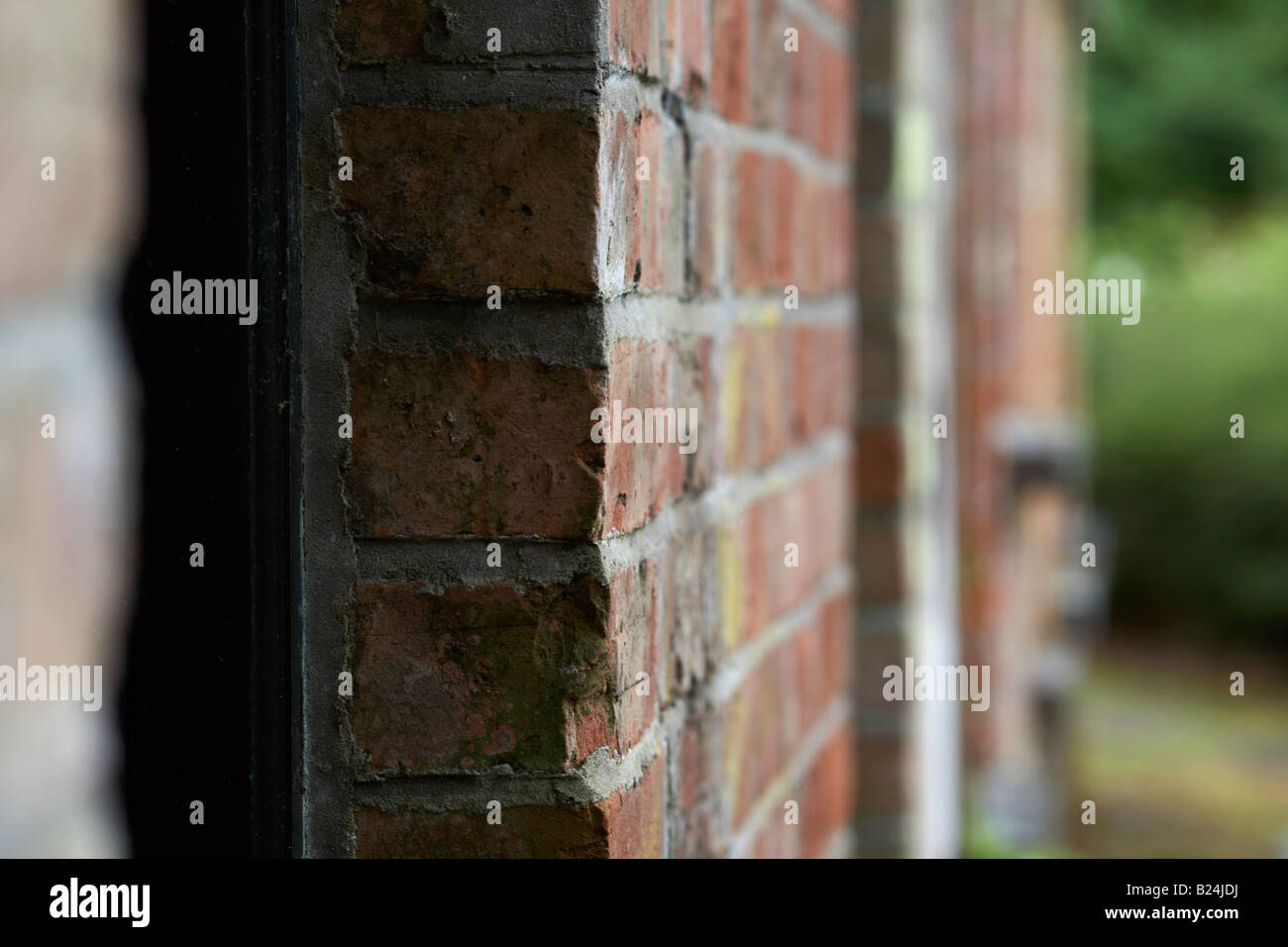 old weathered victorian red brick walls of an abandoned derelict ...