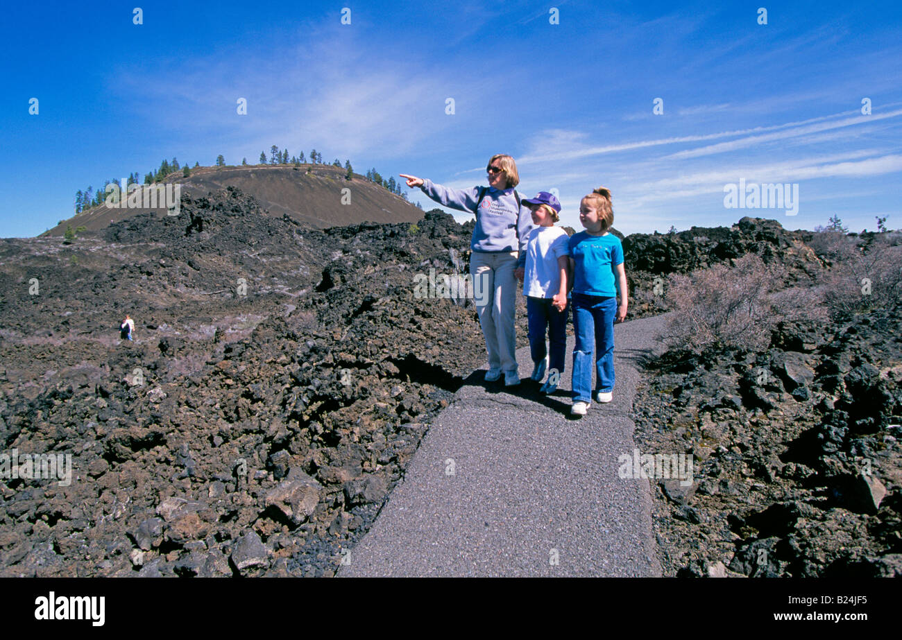 Hikers explore the moonscape landscape of Lava Butte at the Lava Lands ...
