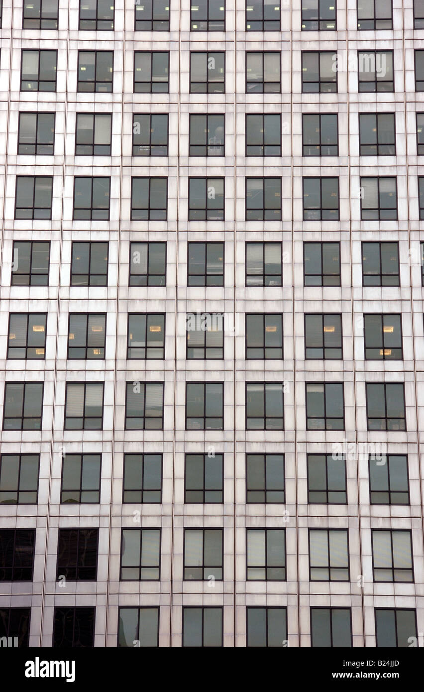 Windows in an office building with curtains pulled on a few in the ...
