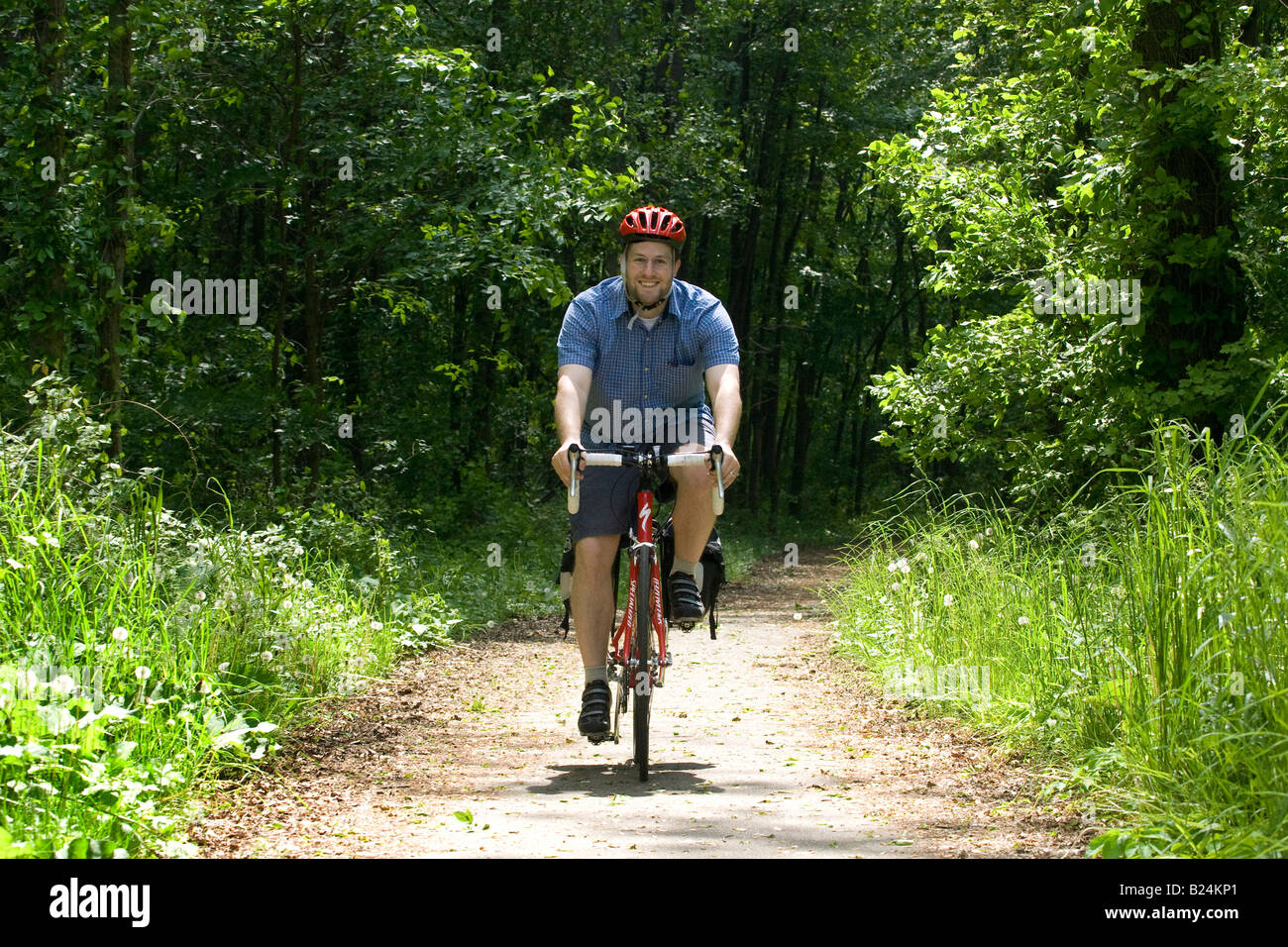 Male bicycle rider rides on country path in Michigan, U.S.A Stock Photo ...