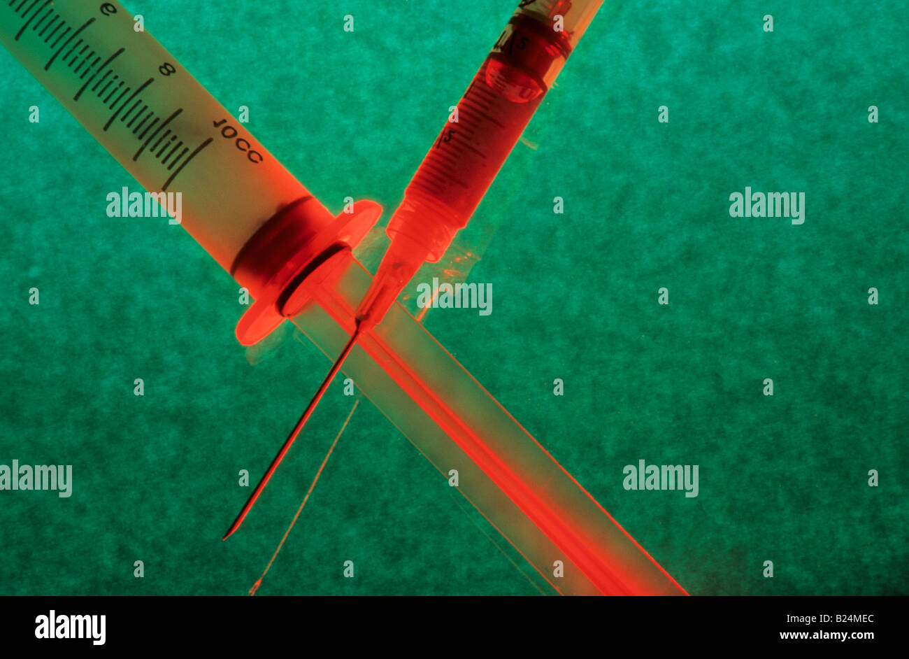 TWO SYRINGES WITH NEEDLES DRAMATIC LIGHTING Stock Photo - Alamy