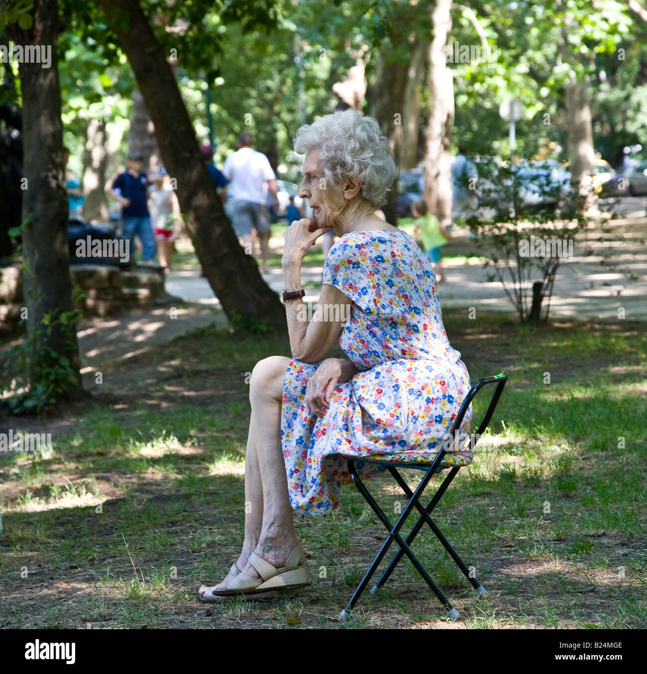 old woman seated alone in park thinking Stock Photo - Alamy