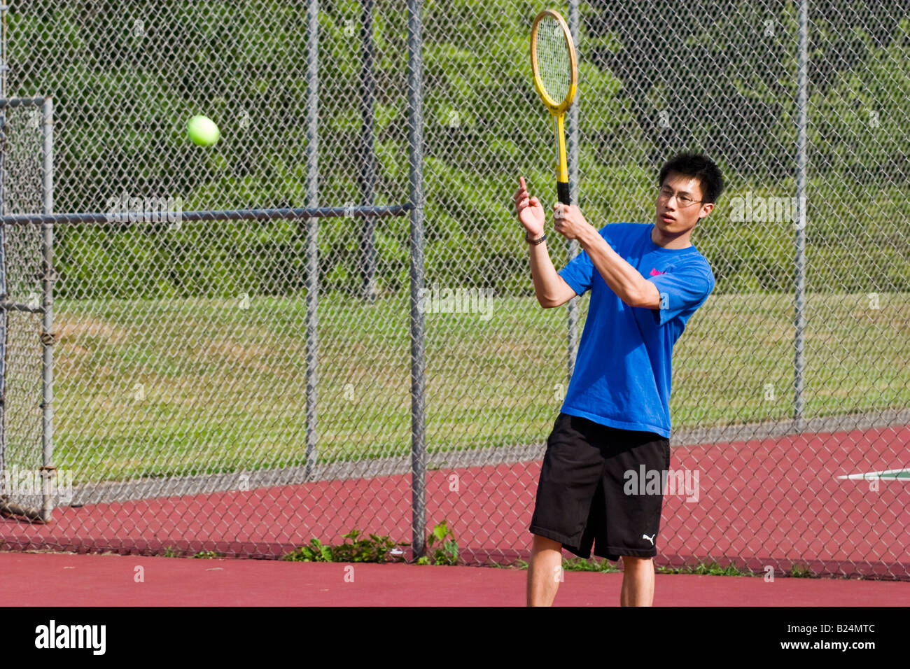 Young Asian man playing tennis Stock Photo - Alamy