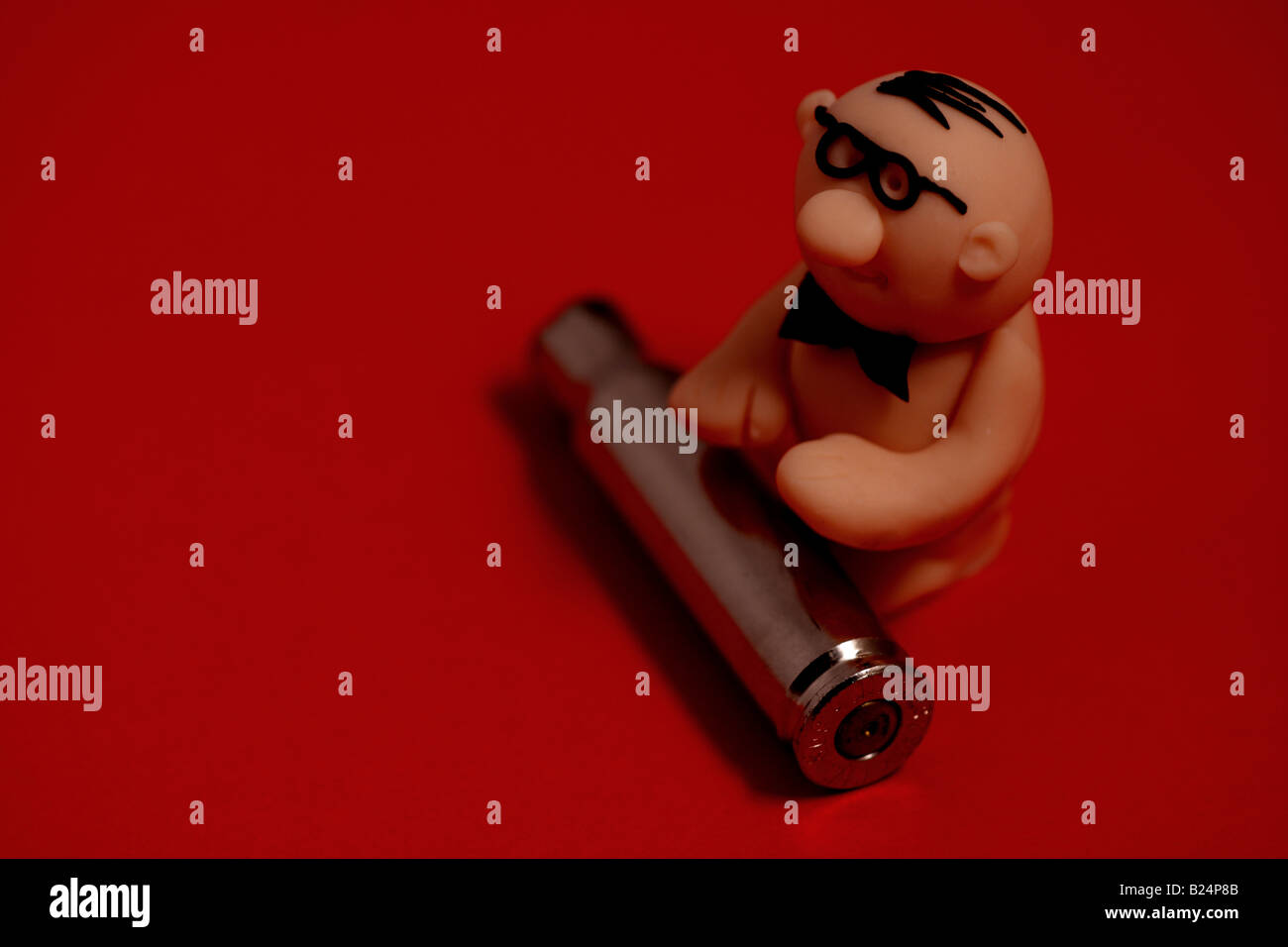 Funky figure holding a shell casing Stock Photo - Alamy