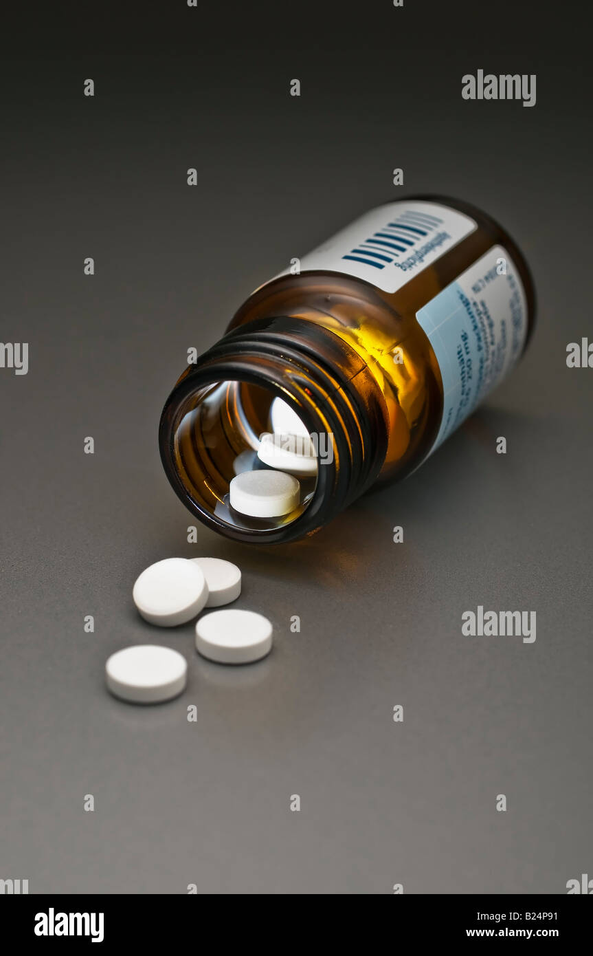 open pill bottle with tablets outside Stock Photo - Alamy