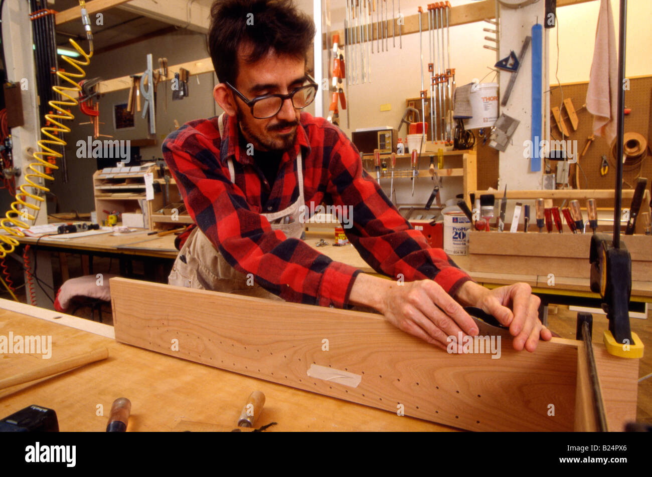 Carpenter planing a shelf in his workshop Stock Photo - Alamy