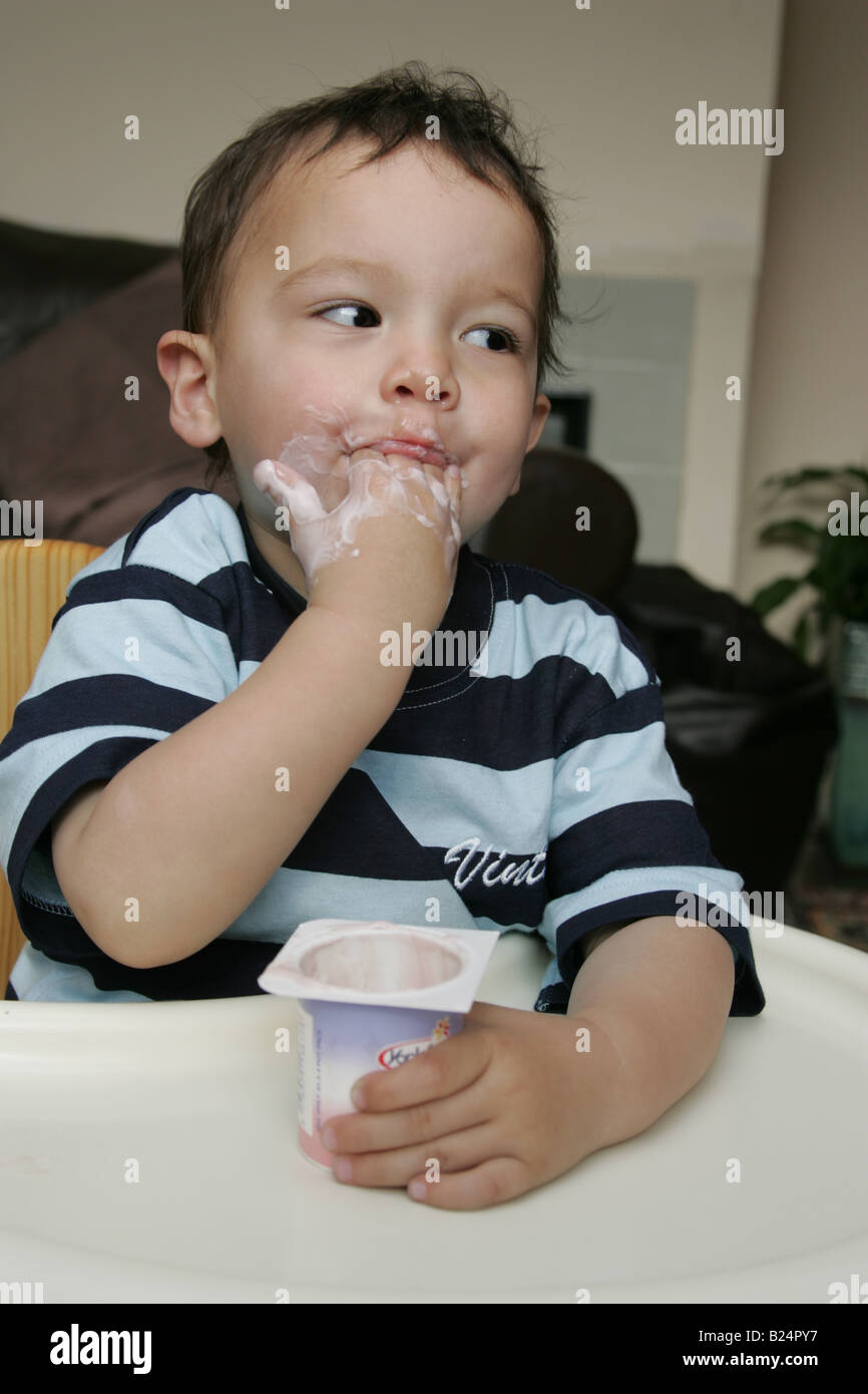 messy tot eating a yoghurt with is hands Stock Photo - Alamy