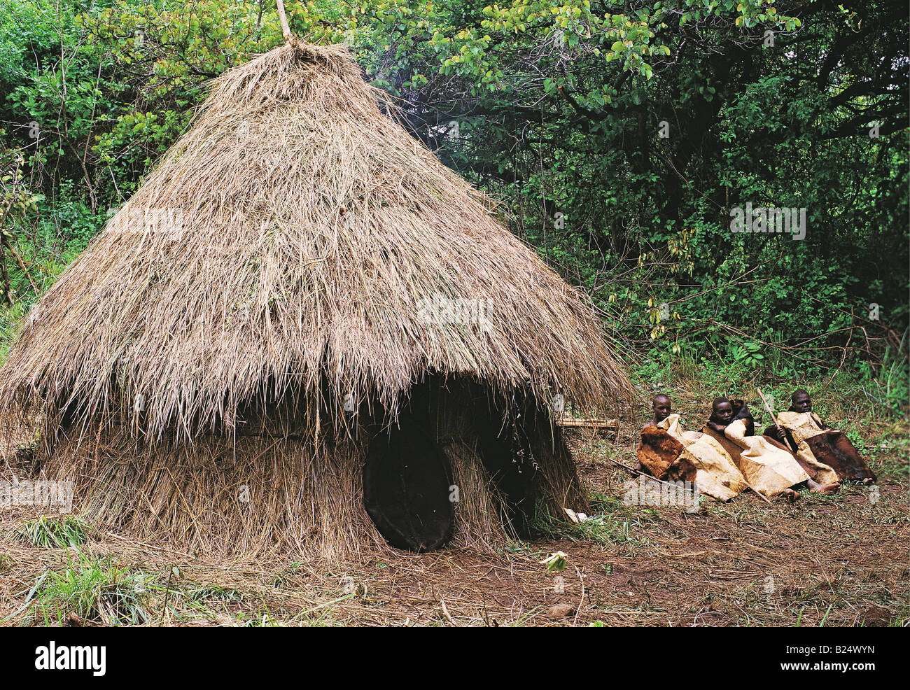 Three Nandi youths in seclusion outside their grass hut after ...