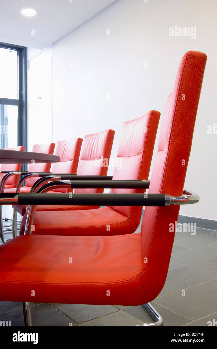 Red leather armchairs in a meeting room Stock Photo - Alamy