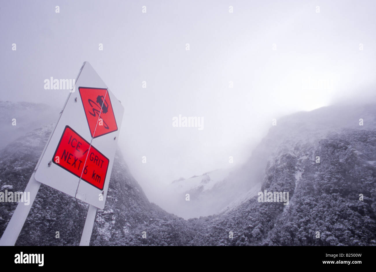 'Beware of Ice' roadsignwith backdrop of snow covered mountains along ...