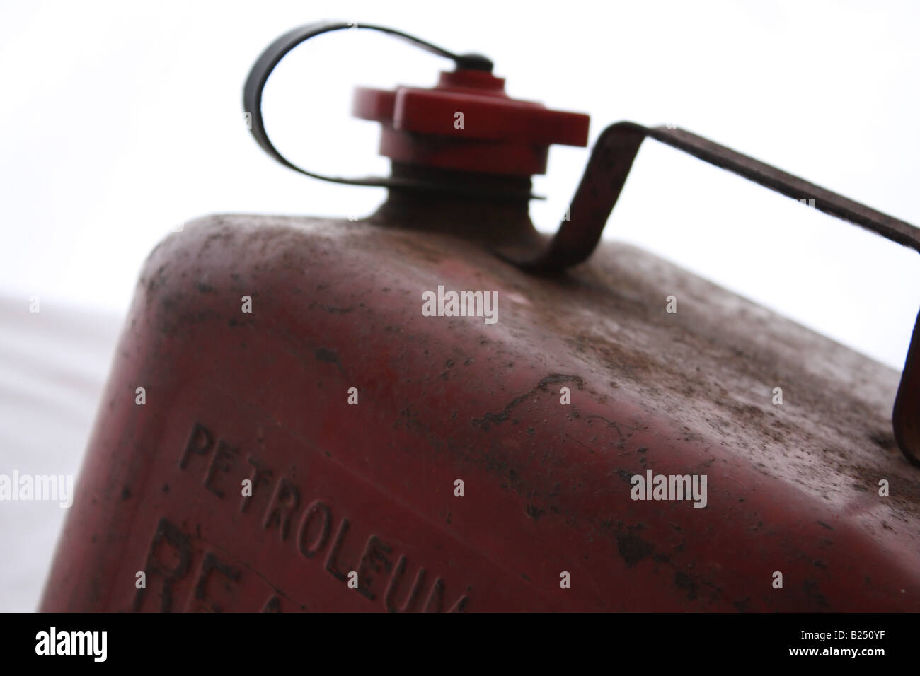 An old red petrol can taken on a white background Stock Photo - Alamy