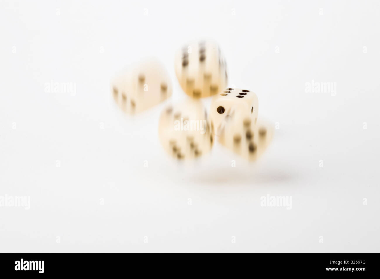 Rolling dice on white background Stock Photo - Alamy