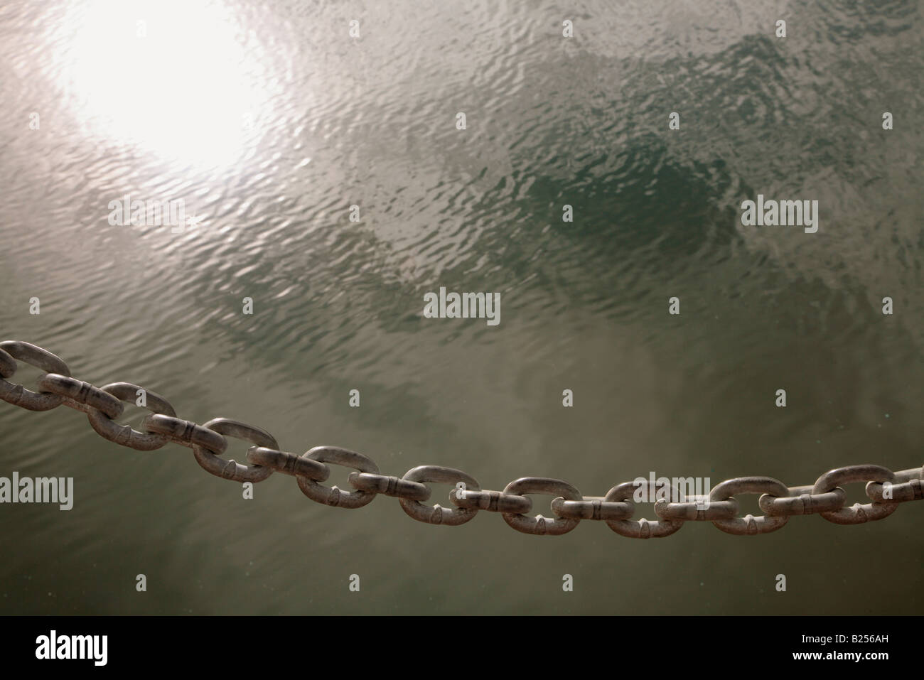 Big grey chain links with clouds reflecting in water background Stock ...