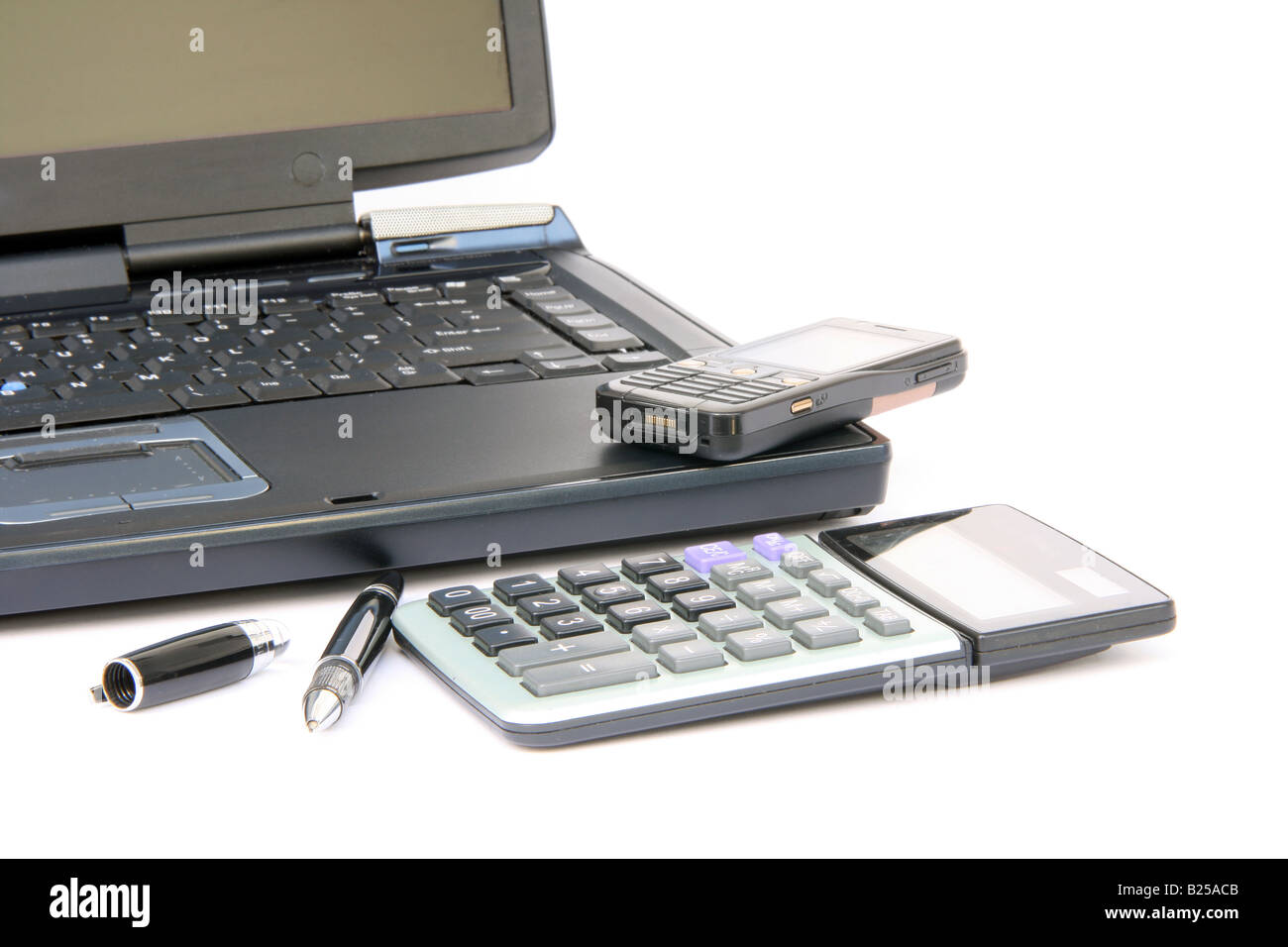 laptop detail with pen cellphone and calculator isolated on white ...