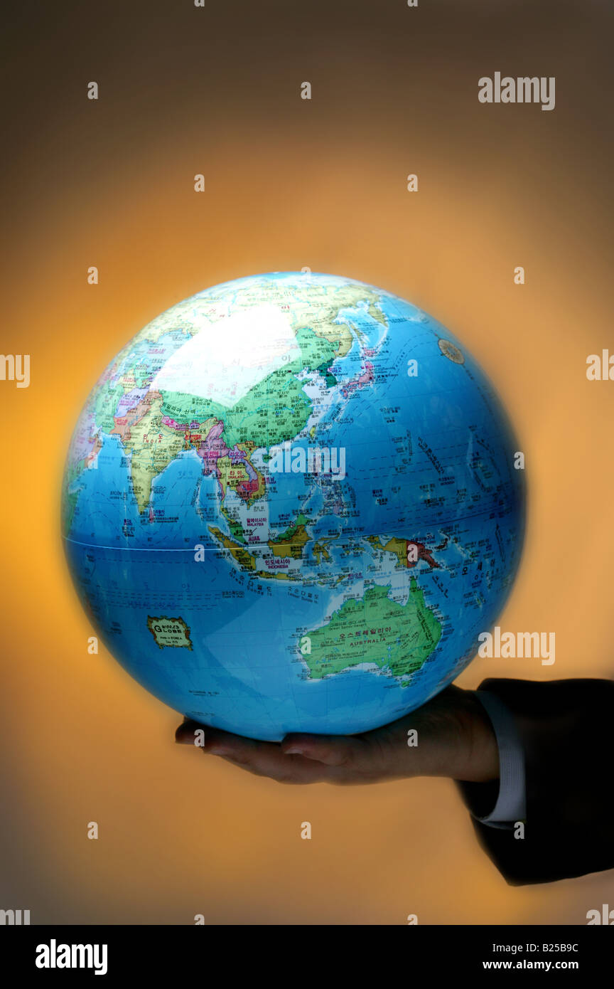 Globe in hand Stock Photo - Alamy