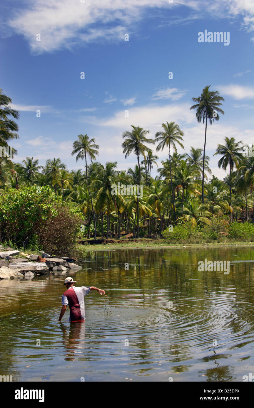 Local fisherman wading in water off the Costa Malabari beach near ...