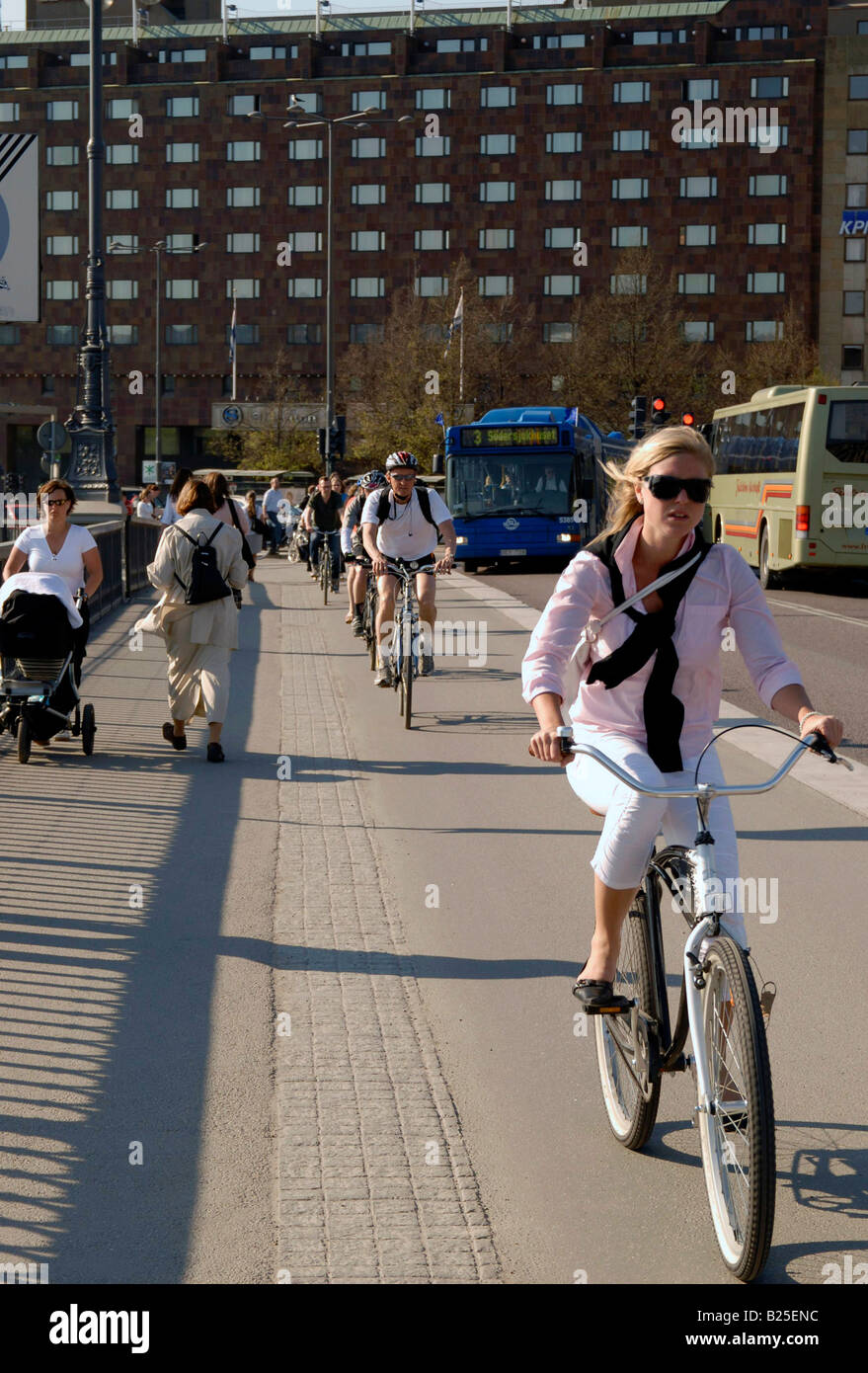 Swedish commuters cycling to work using a cycle lane in central ...