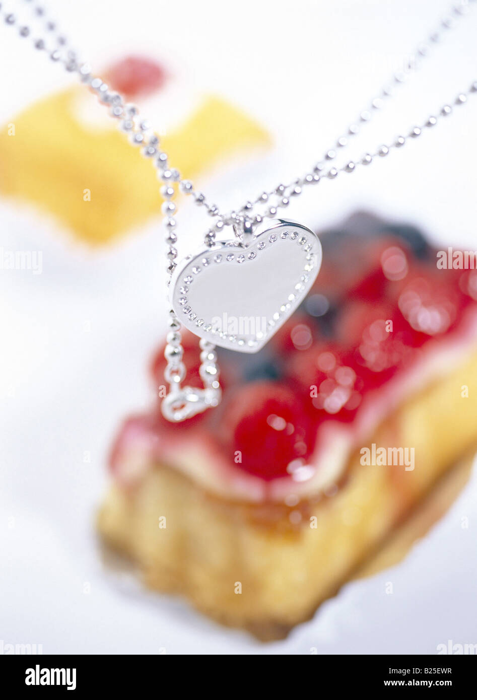 Necklace and cake Stock Photo - Alamy