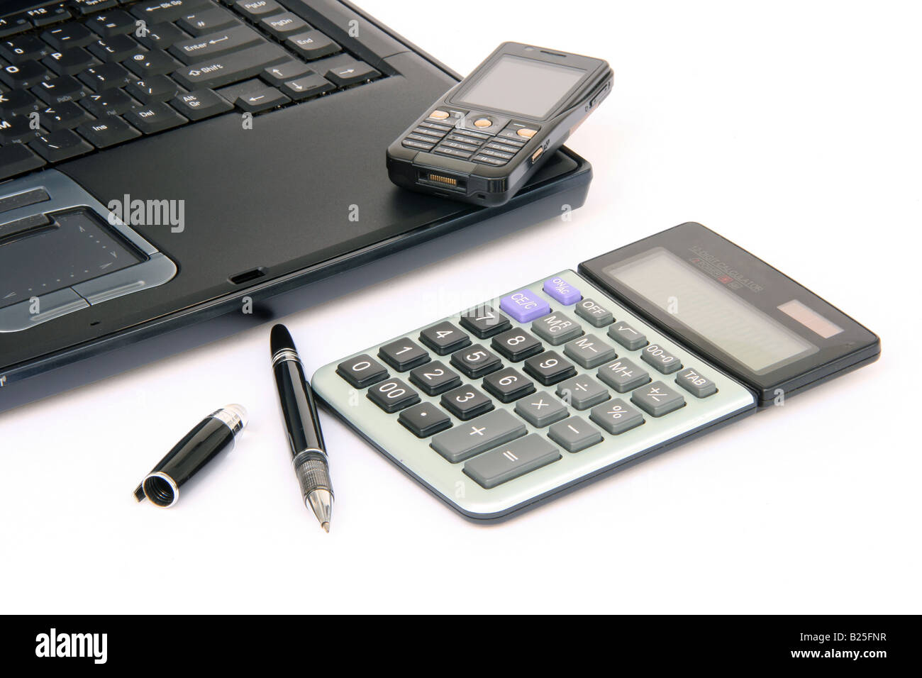 laptop detail with pen cellphone and calculator isolated on white ...