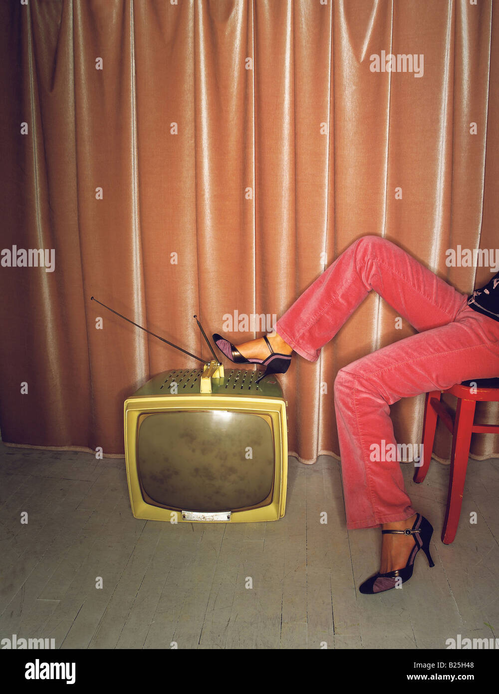 Woman legs on TV Stock Photo - Alamy