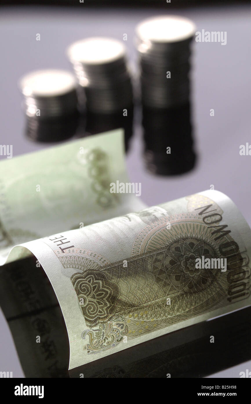 Banknote and coin Stock Photo - Alamy