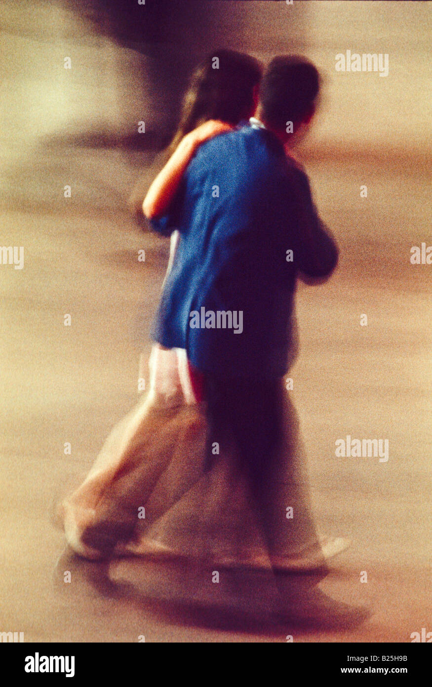 Young couple arm in arm motion movement blur Stock Photo - Alamy