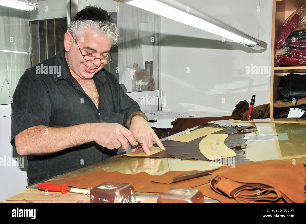 Leather worker making leather coat, Buenos Aires, Argentina Stock Photo ...