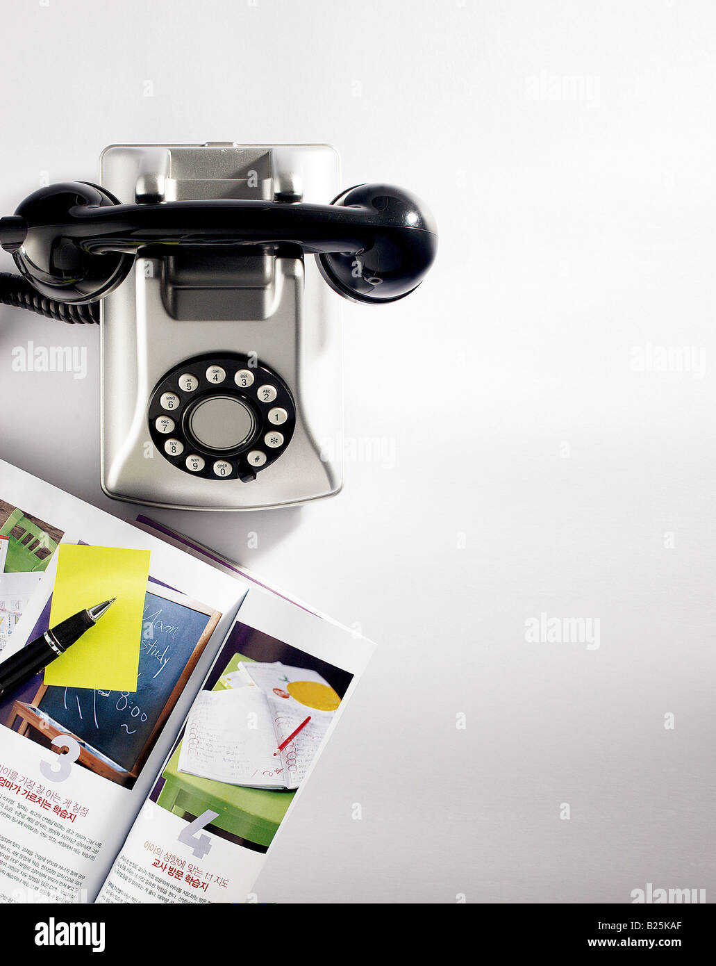 Telephone and magazine Stock Photo - Alamy