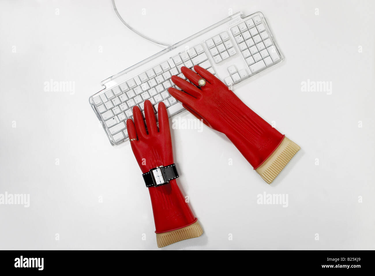 Keyboard and red rubber glove Stock Photo - Alamy