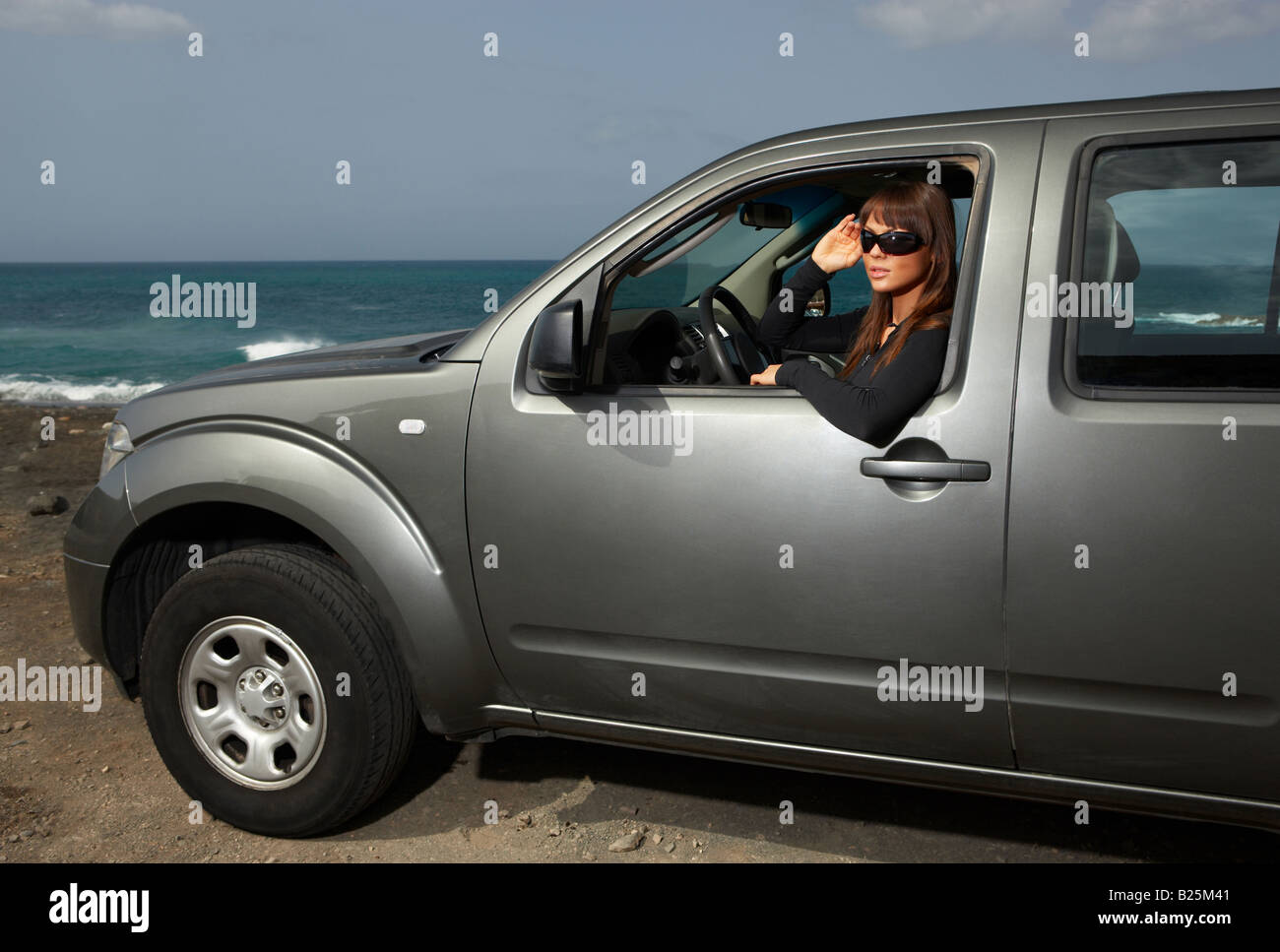 Woman and her 4wd car at the beach Stock Photo - Alamy