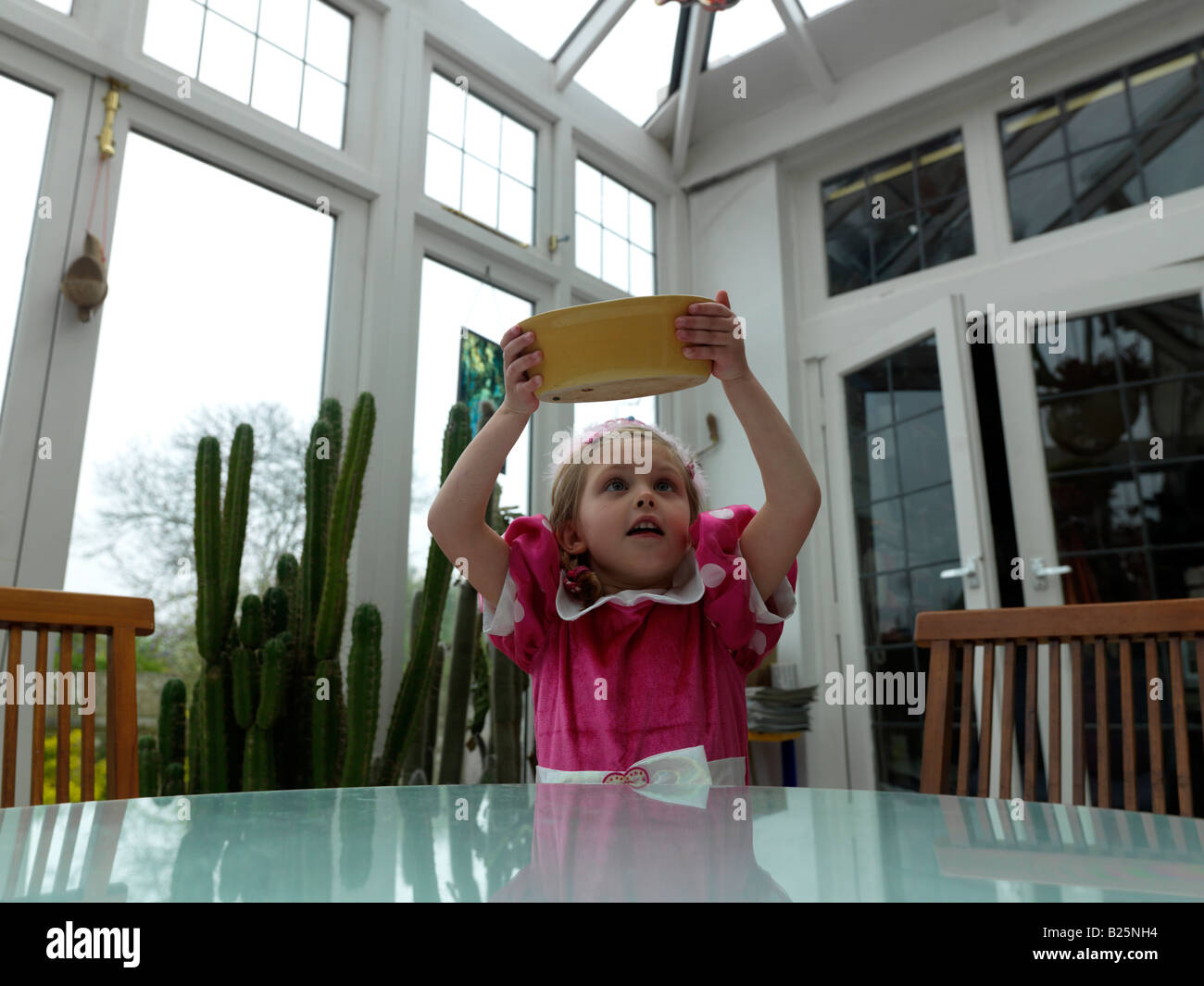 Four Year Old Girl Lifting a Pot Stock Photo - Alamy