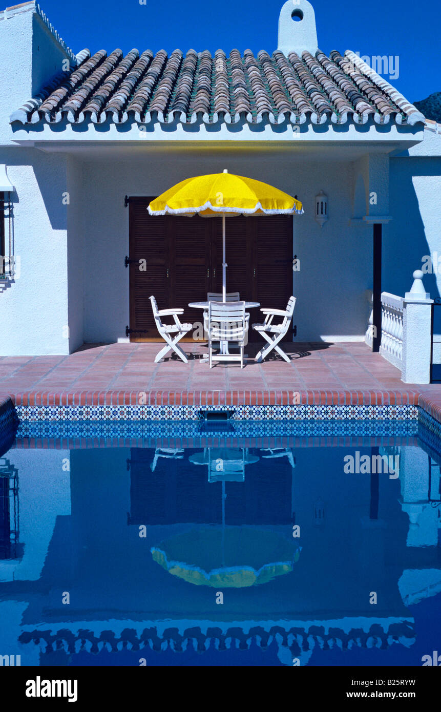 Sunny terrace with pool and sun shade Stock Photo - Alamy