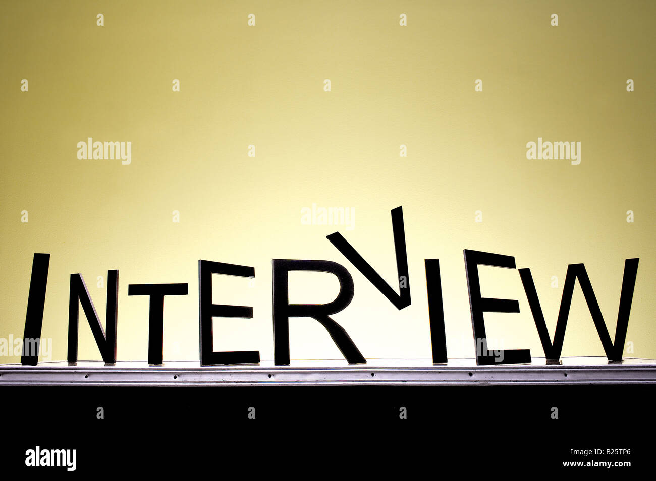 Alphabet interview on yellow background Stock Photo - Alamy