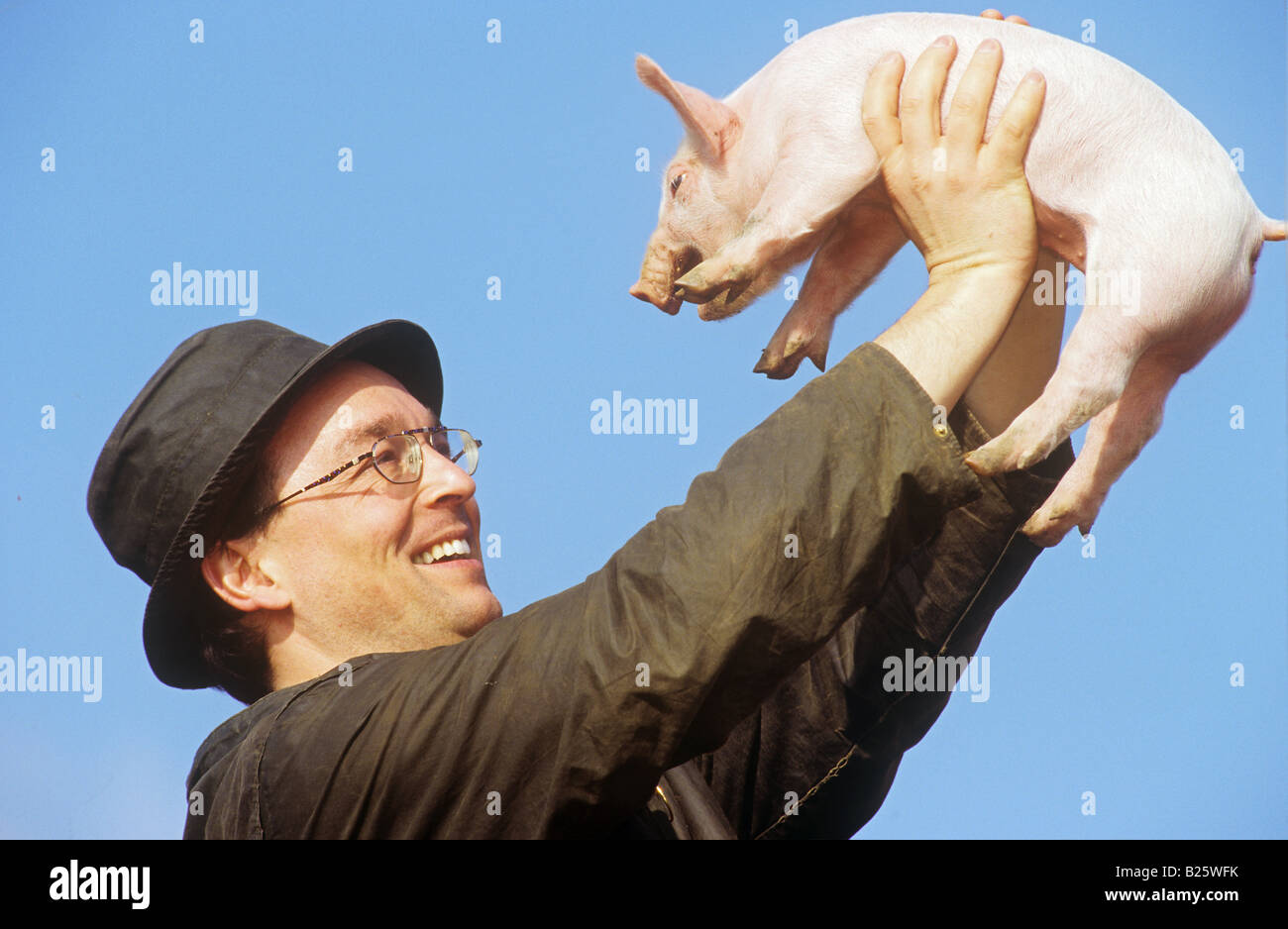 chimney-sweeper lifting piglet Stock Photo - Alamy