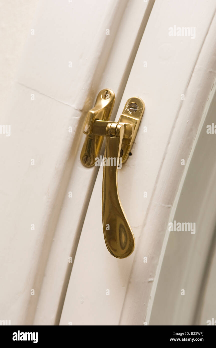 Detail of closed window with golden handle Stock Photo - Alamy