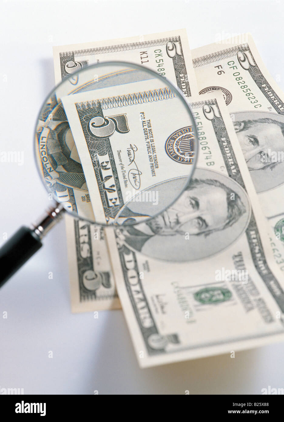 Magnifying glass and dollar Stock Photo - Alamy