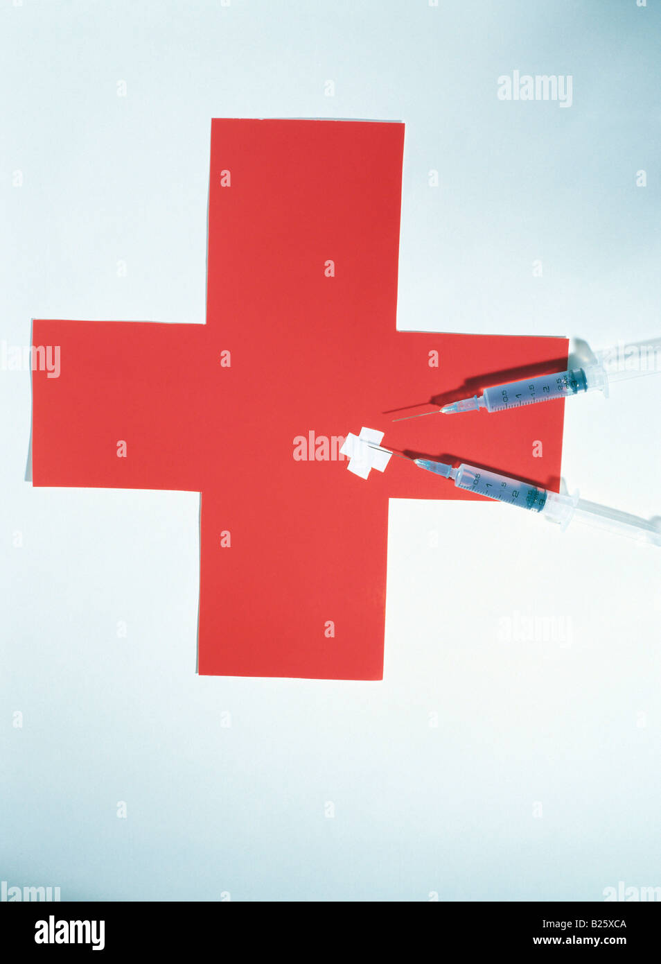 Syringe and red Cross Stock Photo - Alamy
