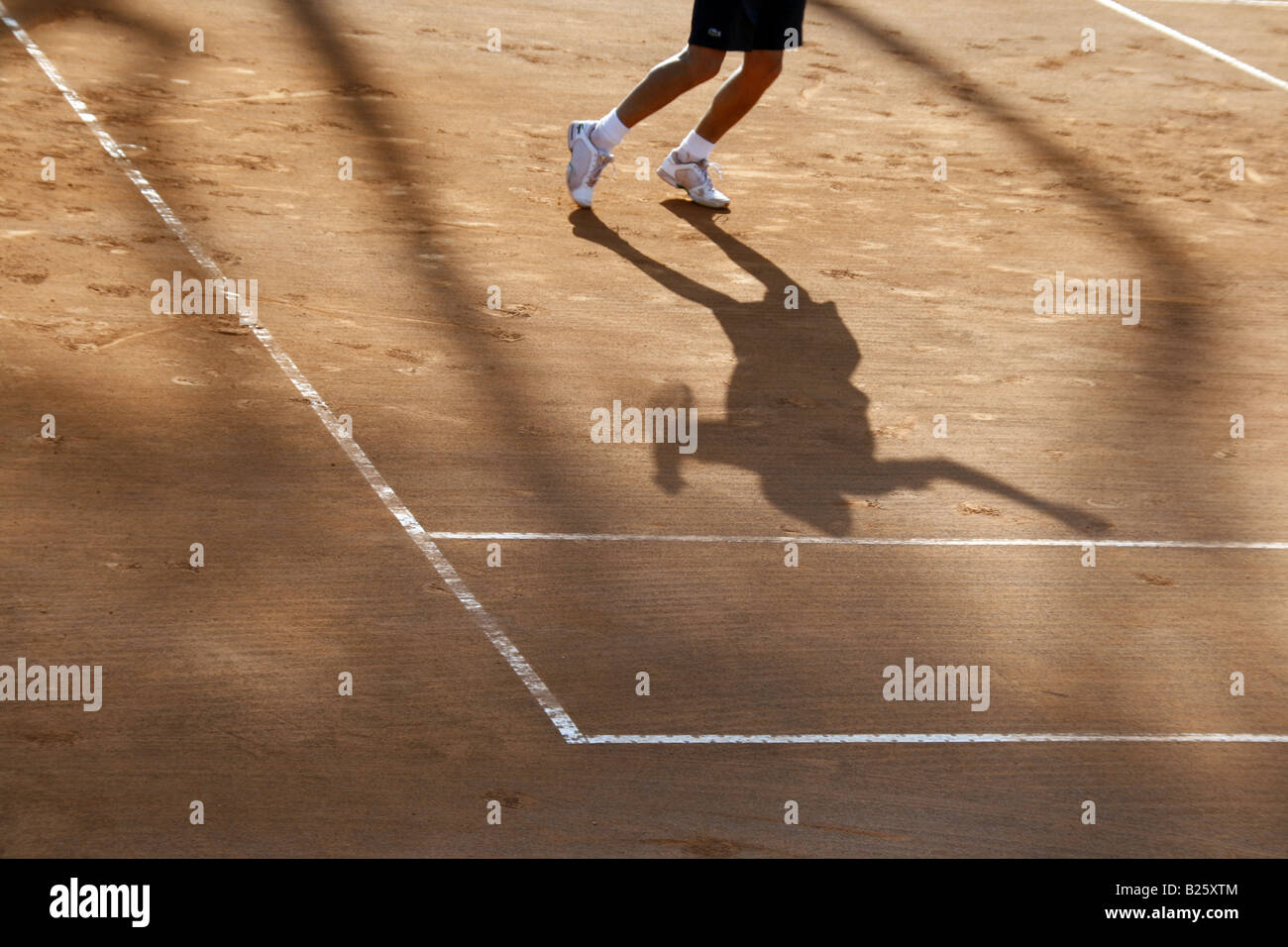 shadow of tennis player in action on court Stock Photo - Alamy