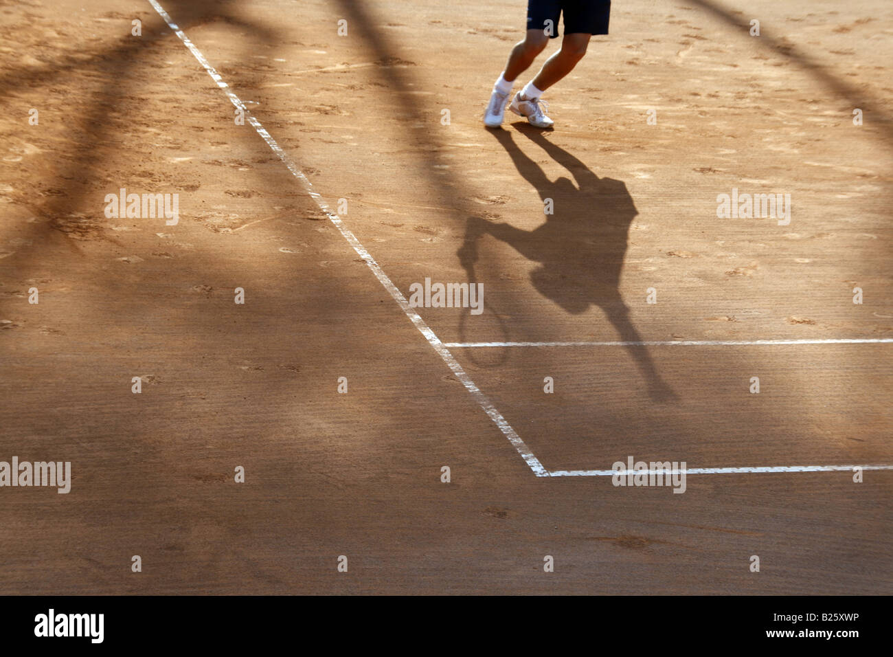 shadow of tennis player in action on court Stock Photo - Alamy