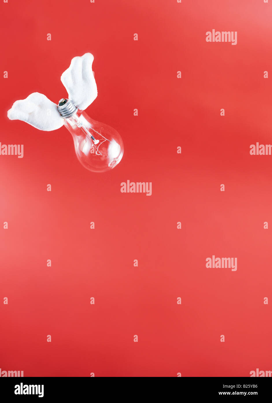 Light bulb with wing on red background Stock Photo - Alamy