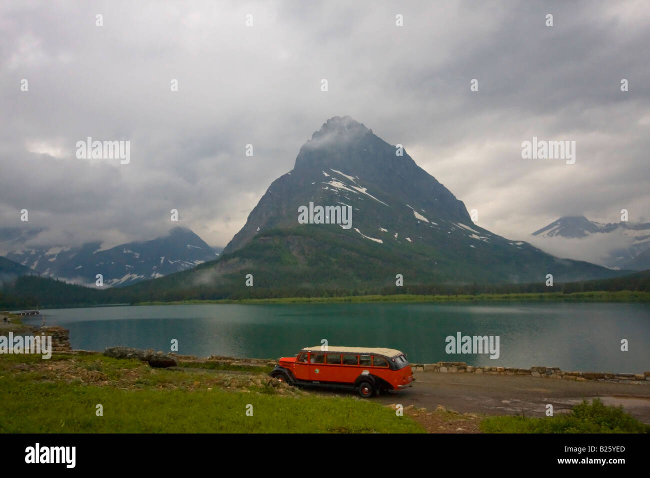 A Red Jammer Passing Swiftcurrent Lake and Grinnell point in early ...