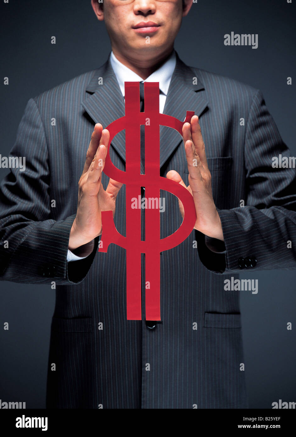 Businessman holding money symbol Stock Photo - Alamy