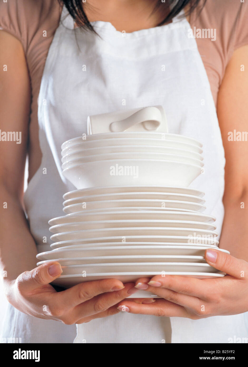 Woman holding dishes Stock Photo - Alamy